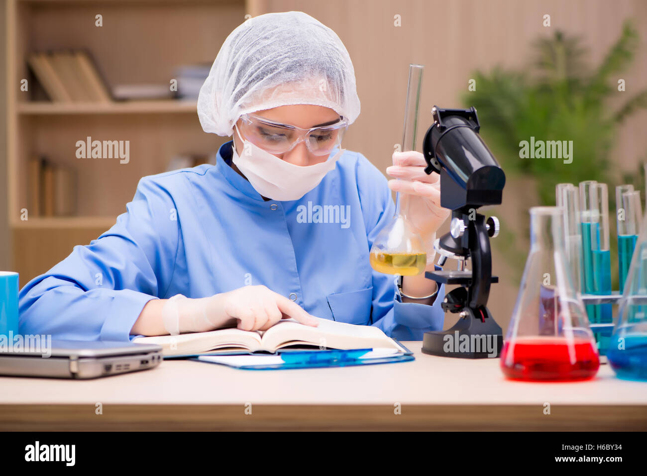 Lab chemist working with microscope and tubes Stock Photo - Alamy