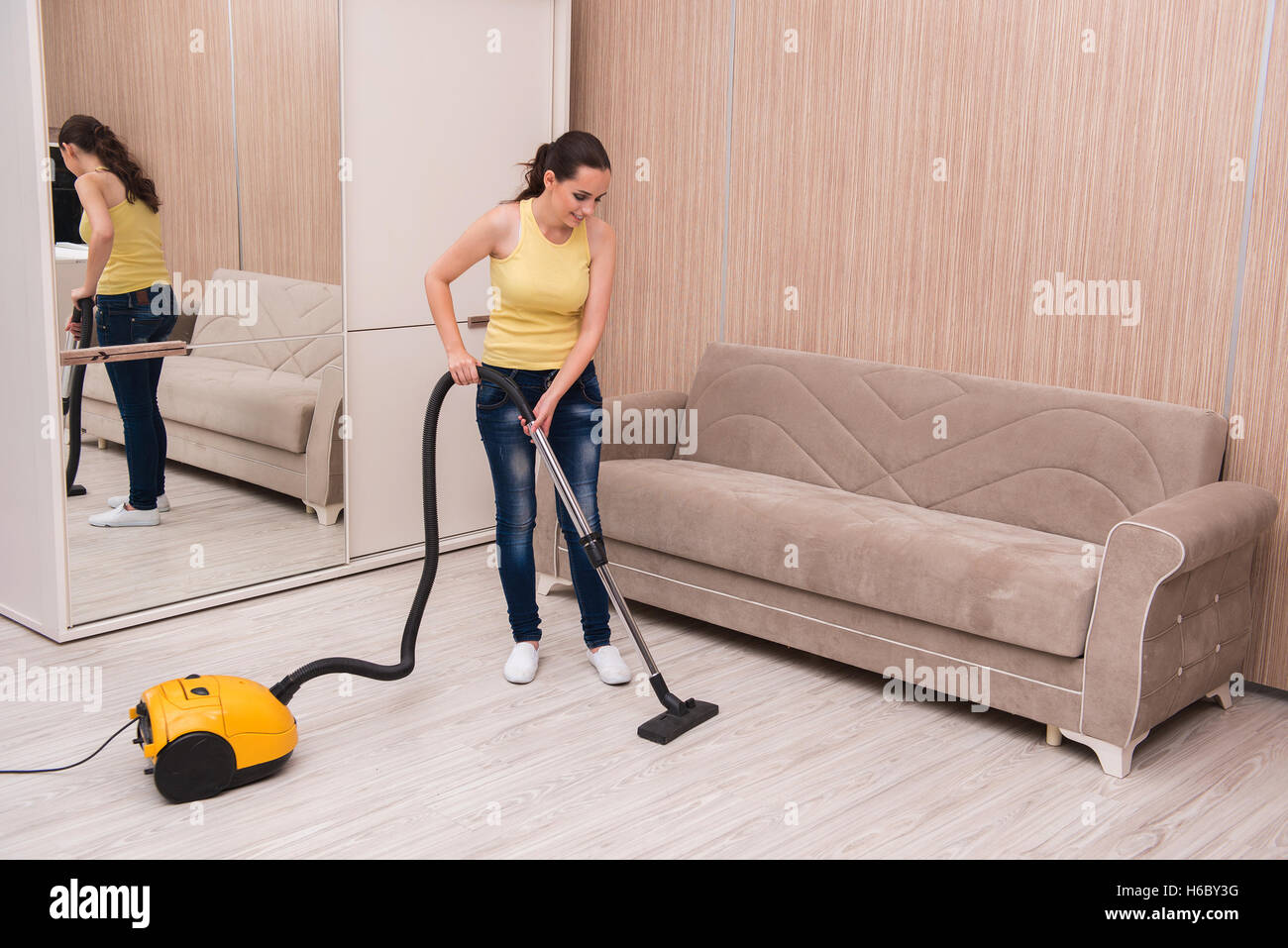 Young woman doing cleaning at home Stock Photo - Alamy