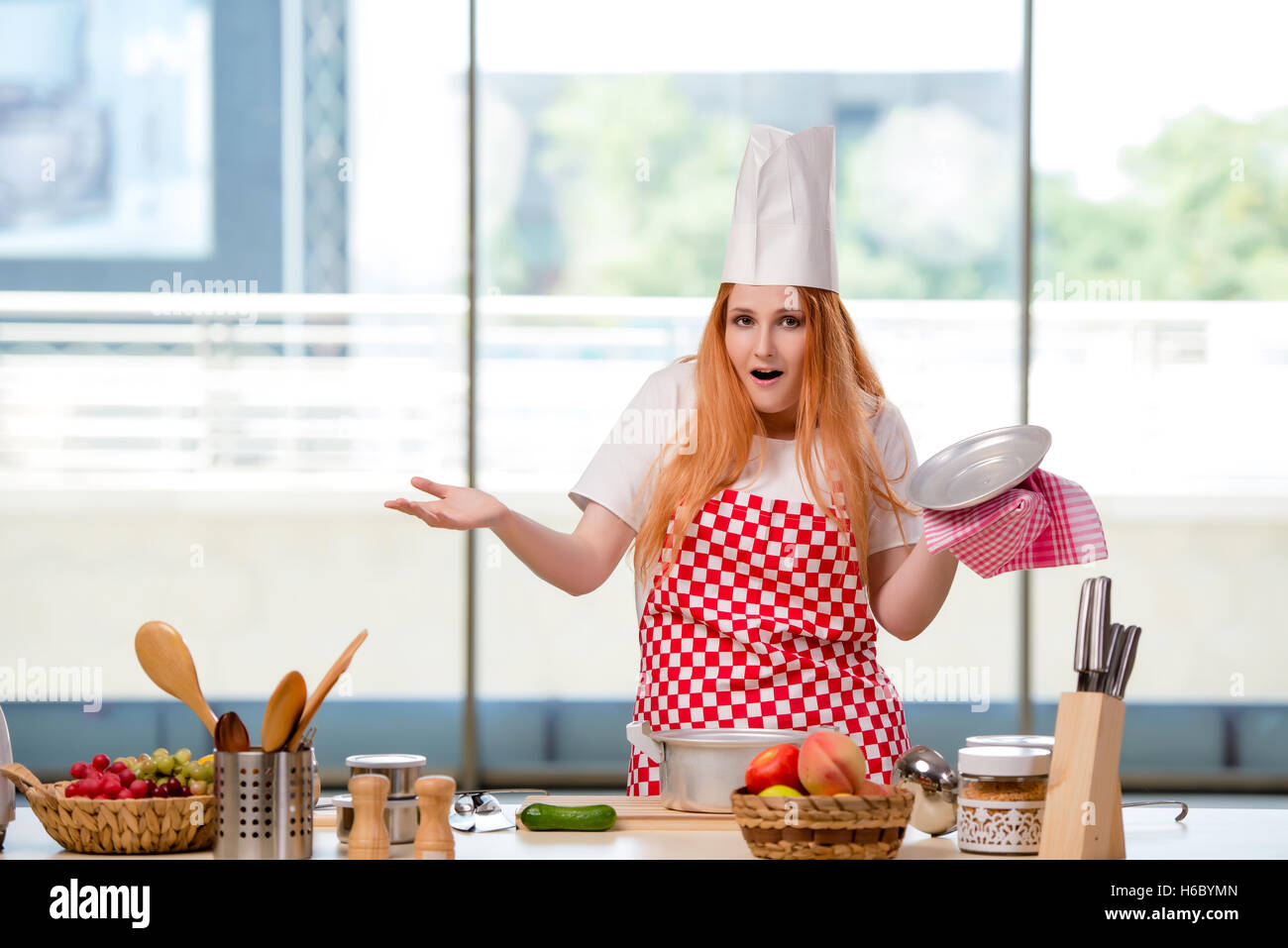 Redhead cook working in the kitchen Stock Photo - Alamy