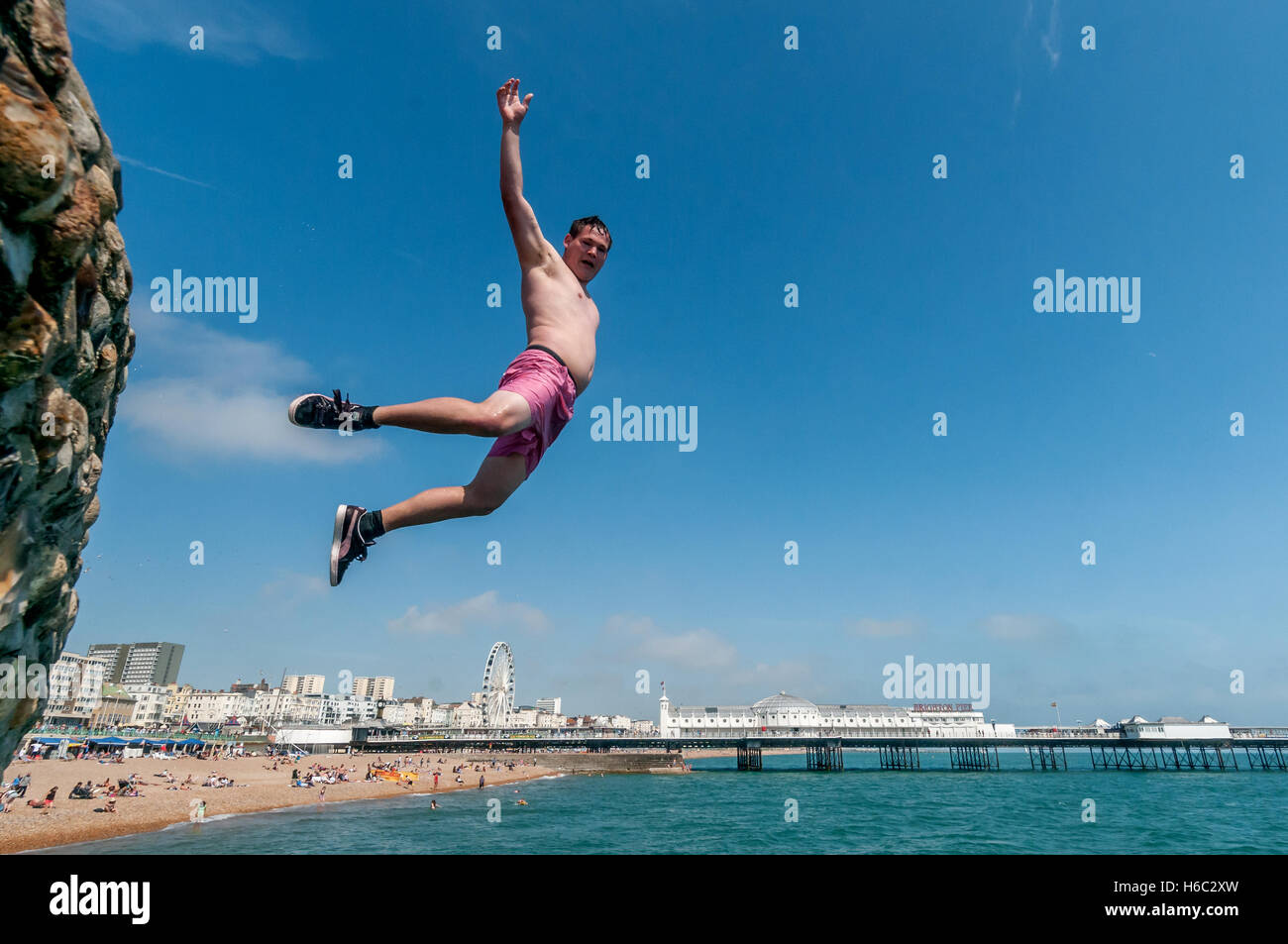 Boy diving into the sea on Brighton beach Stock Photo - Alamy