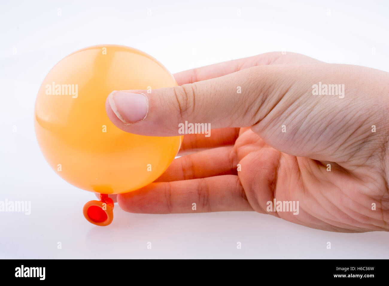 Hand holding a Colorful small balloon on a white background Stock Photo ...