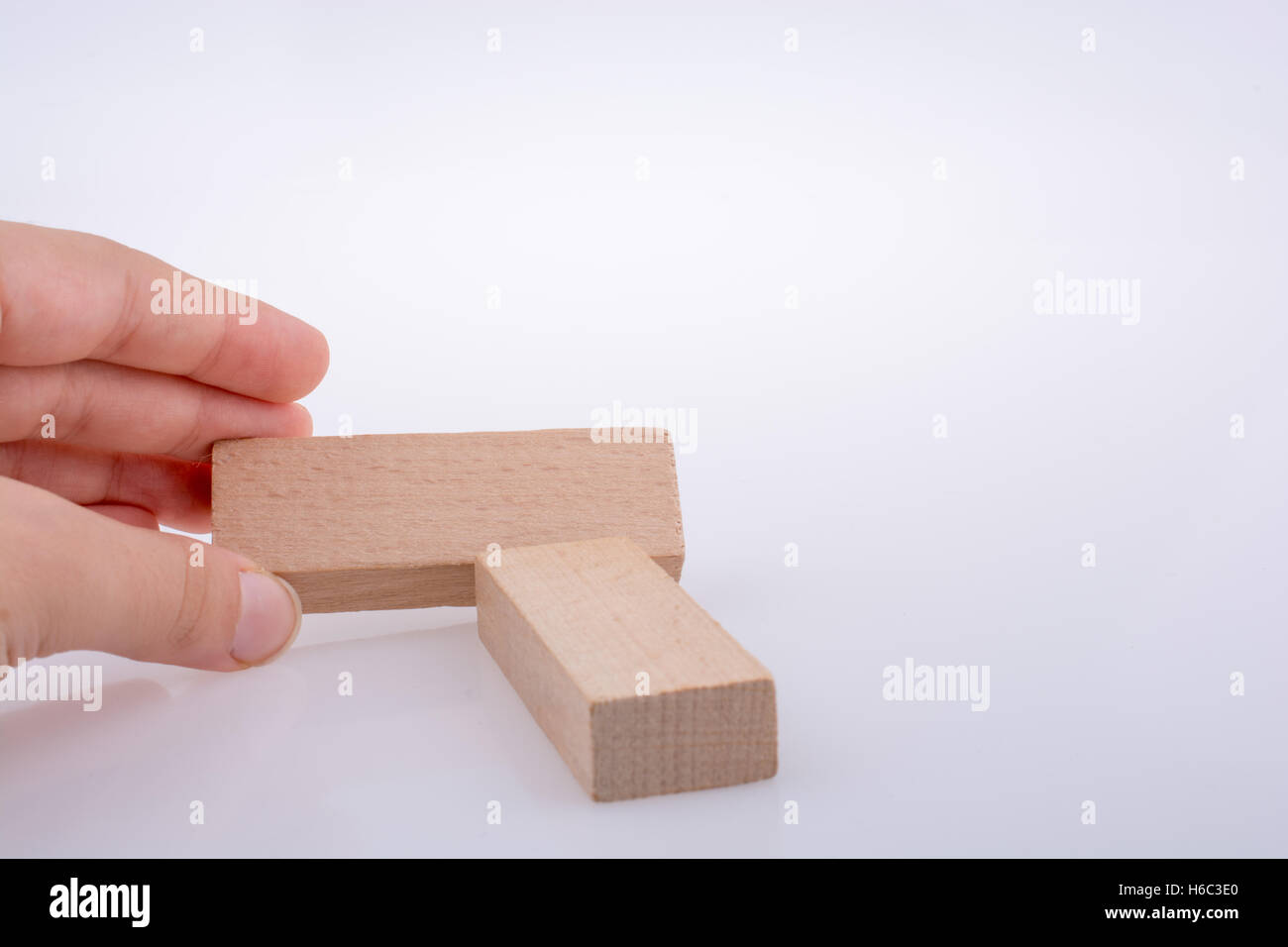 Wooden domino pieces positioned on white background Stock Photo - Alamy