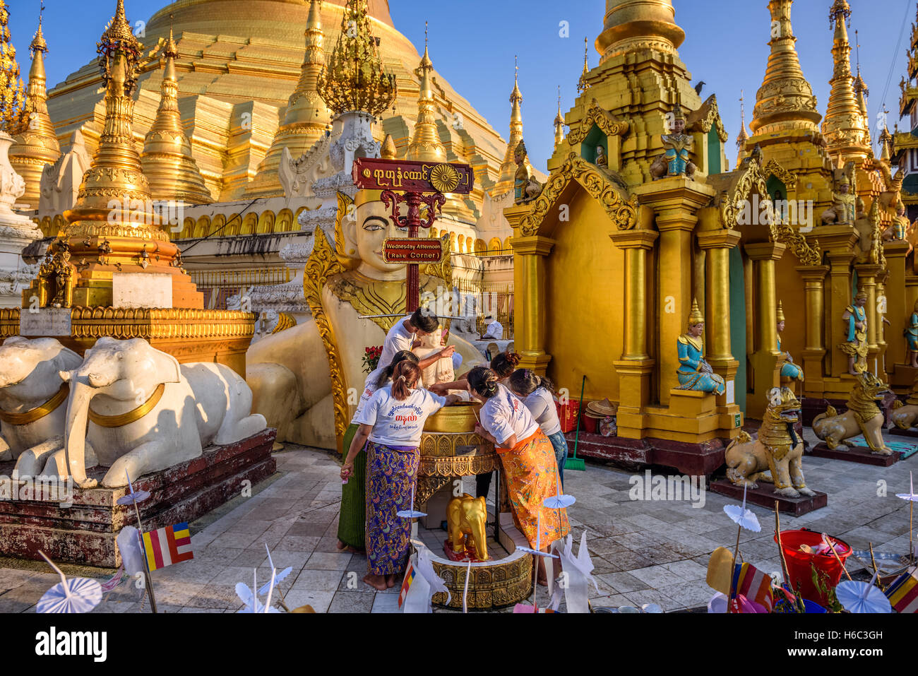 People doing religious rituals at the Shwedagon Pagoda Temple in Yangon ...