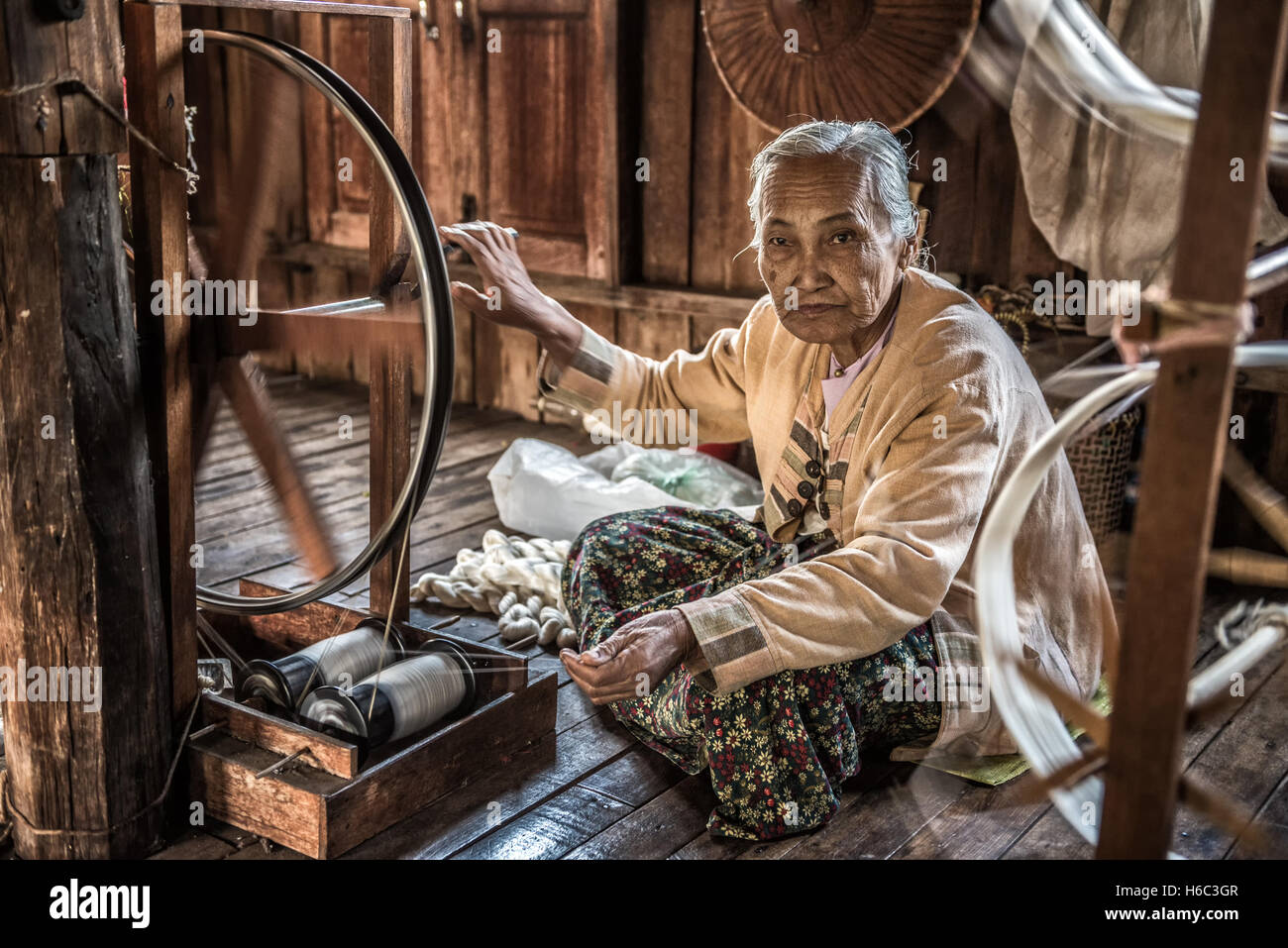Woman worker weaves fabric in a weaving factory on Inle Lake Stock ...
