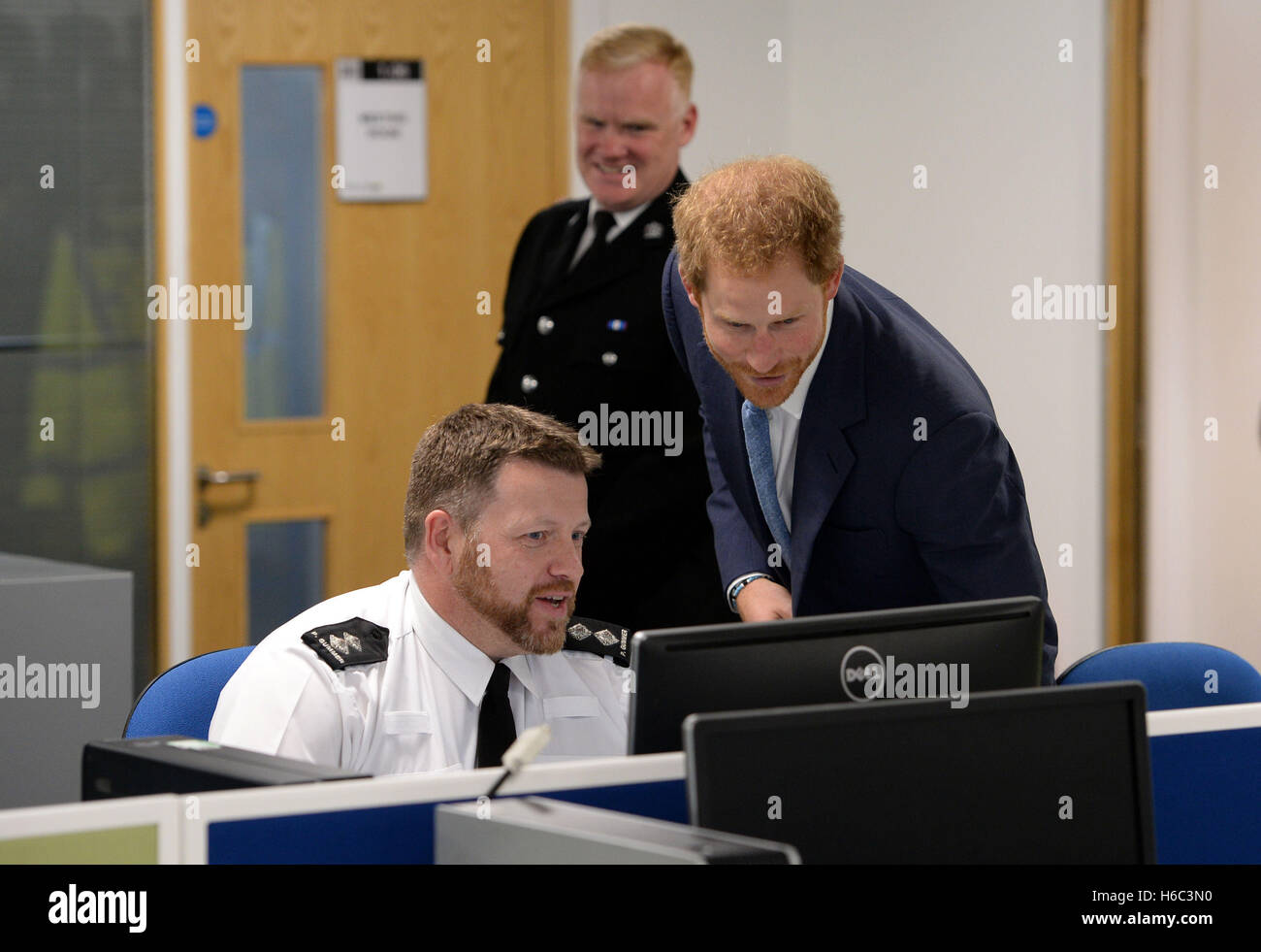 Prince Harry meets Inspector Paul Gummer (left) at the opening of ...