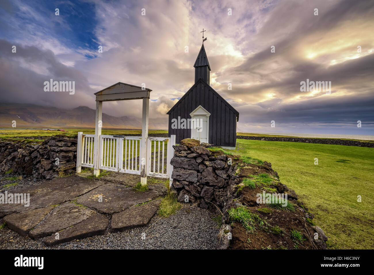 Entry gate and black wooden church of Budir in Iceland Stock Photo - Alamy