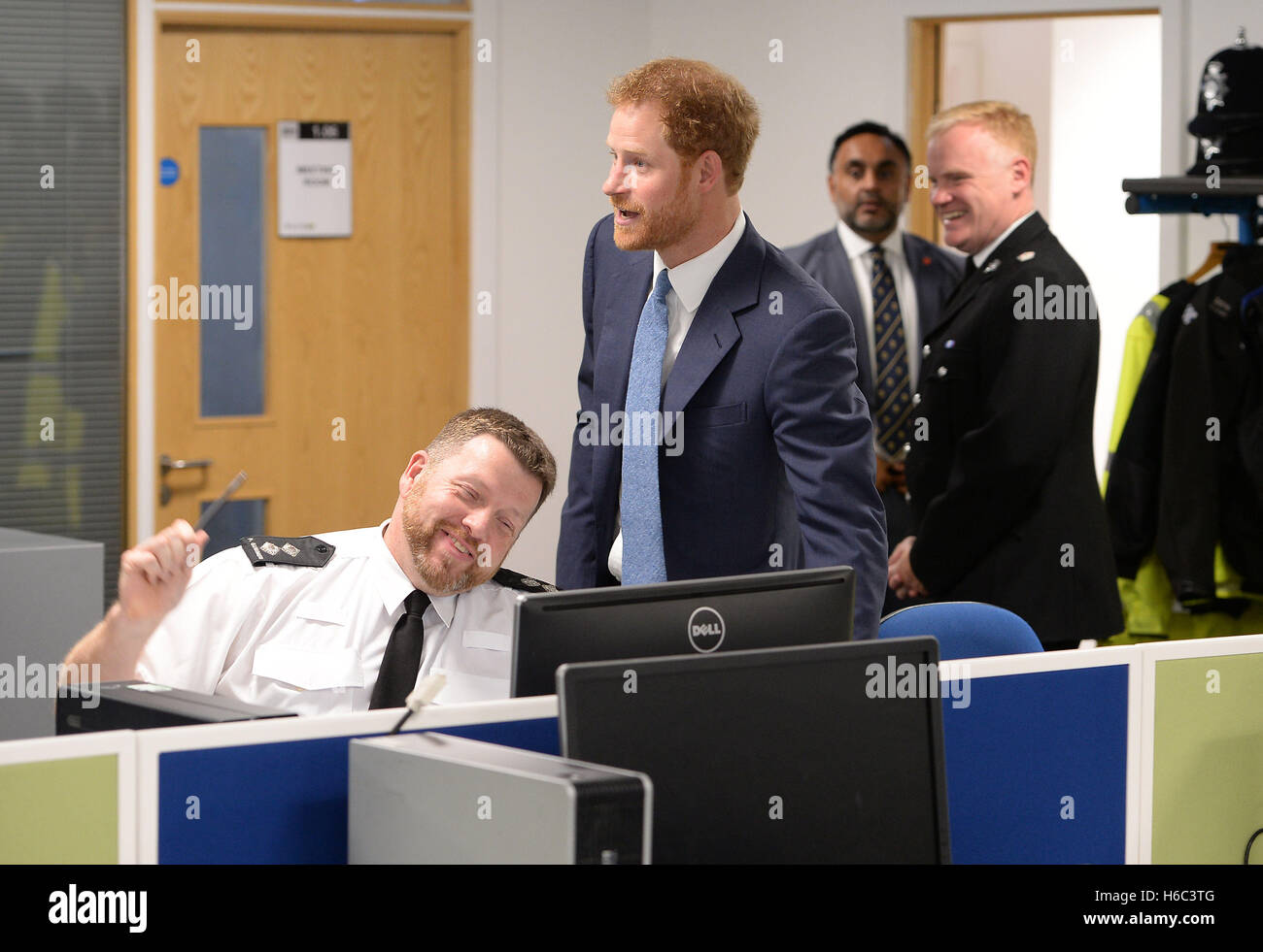 Prince Harry shares a joke with Inspector Paul Gummer (left) at the ...