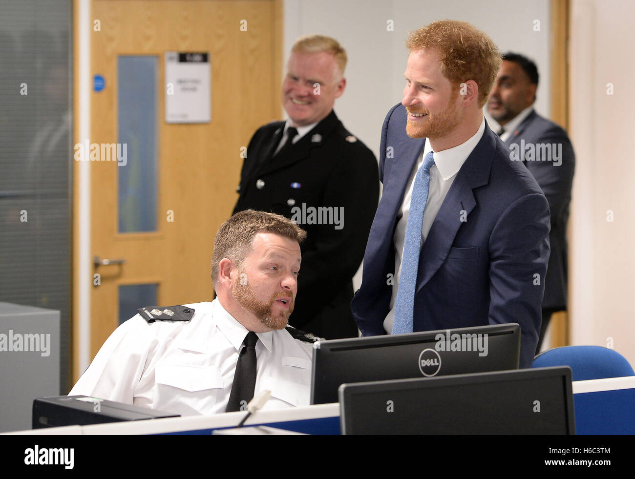 Prince Harry shares a joke with Inspector Paul Gummer (left) at the ...