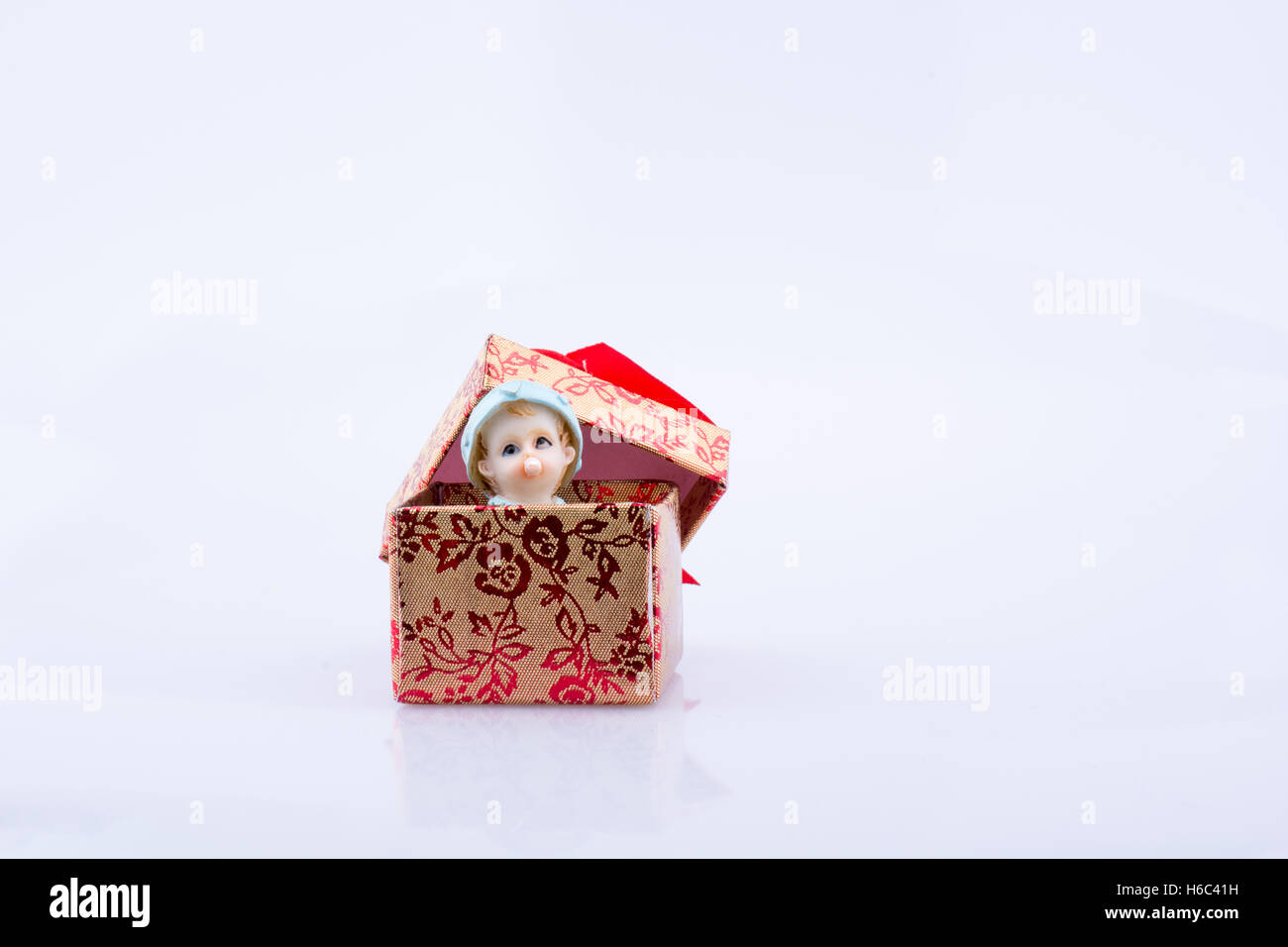 Little baby figure in a gift box Stock Photo - Alamy