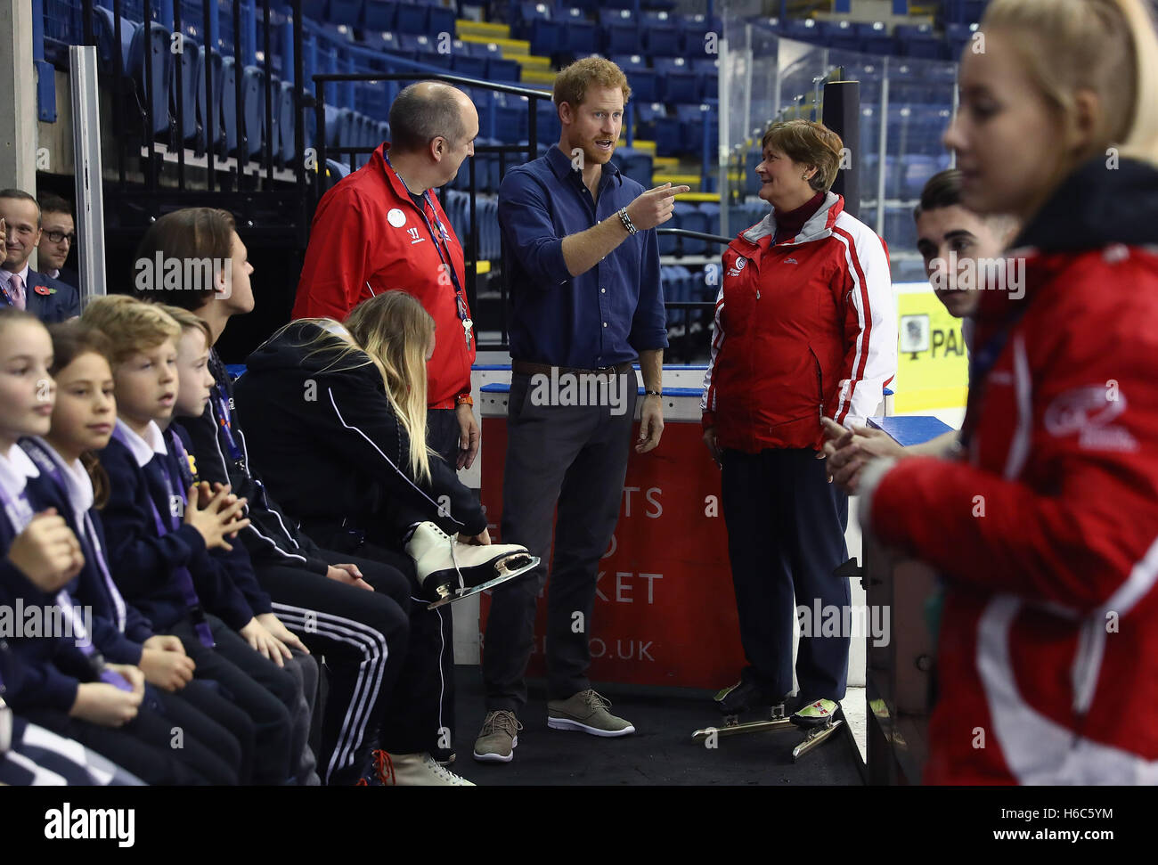 Prince Harry talks to coaches during a visit to the National Ice Centre ...
