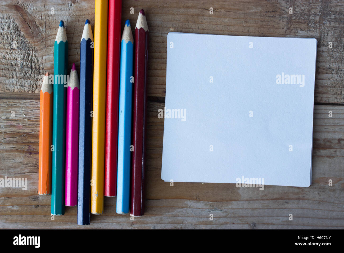 colorful crayons and peace of paper, mock up Stock Photo - Alamy