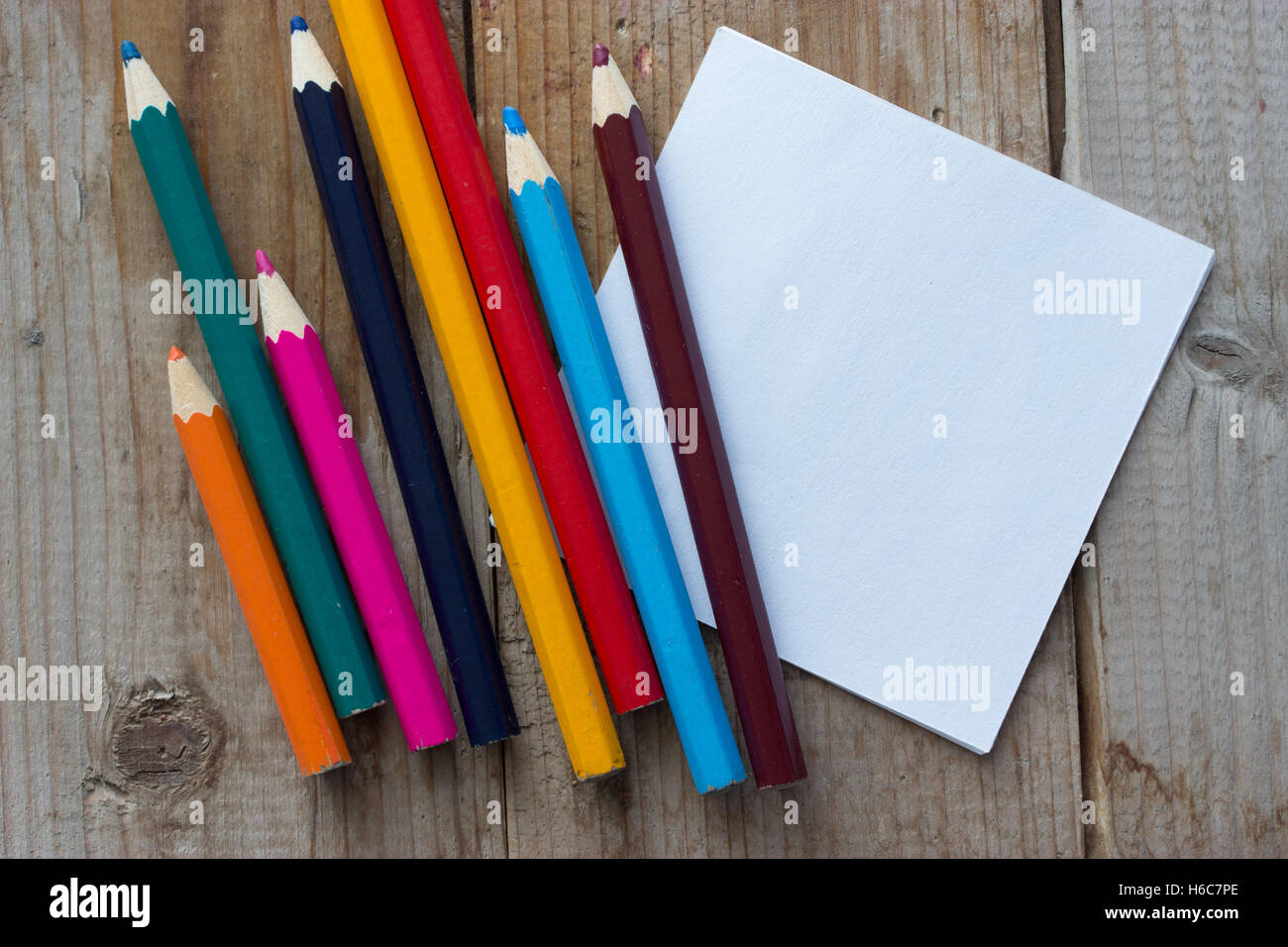 colorful crayons and peace of paper, mock up Stock Photo - Alamy