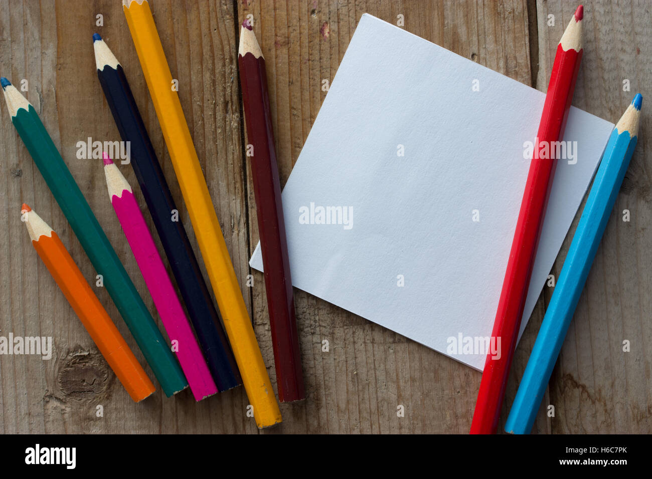 colorful crayons and peace of paper, mock up Stock Photo - Alamy