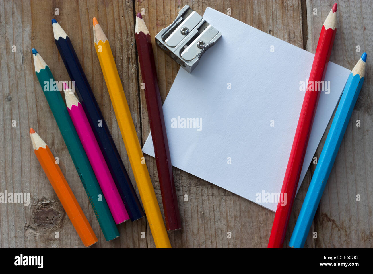 colorful crayons and peace of paper, mock up Stock Photo - Alamy