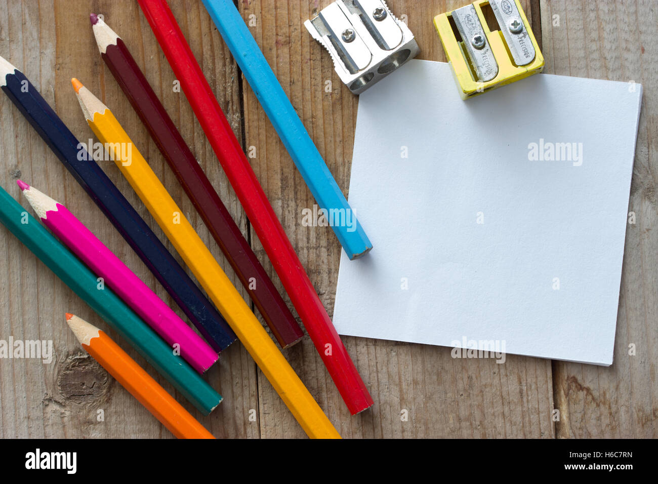 colorful crayons and peace of paper, mock up Stock Photo - Alamy