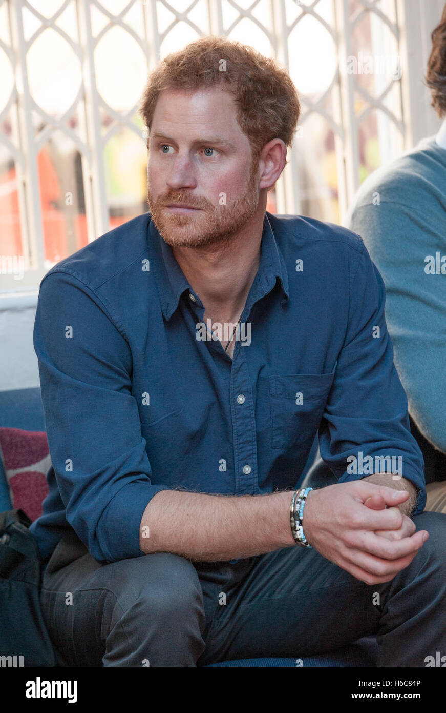 Prince Harry watches a performance of a play during a visit to a ...