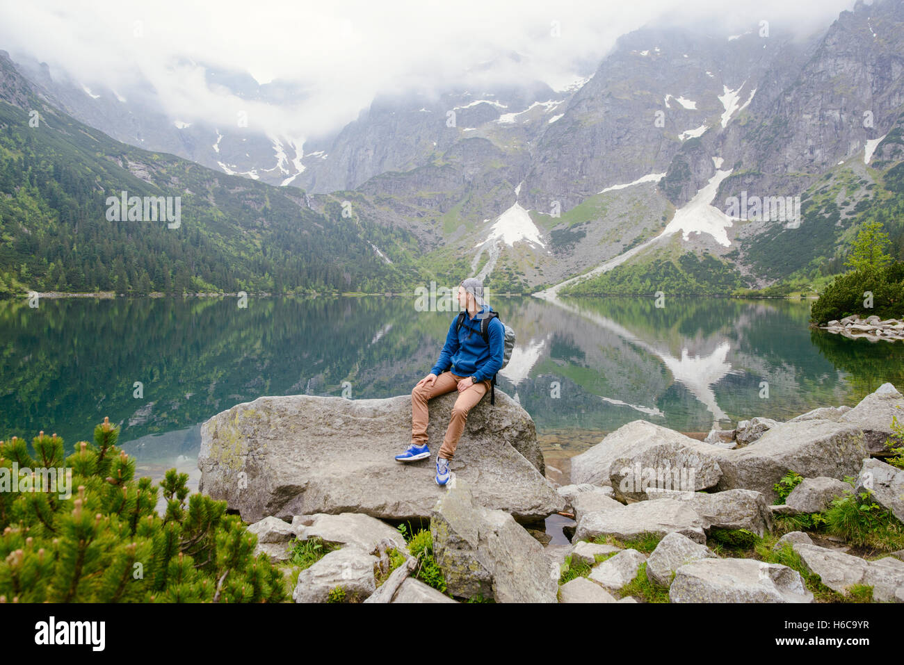 man relaxing on the lake and mountains sunny landscape Stock Photo - Alamy