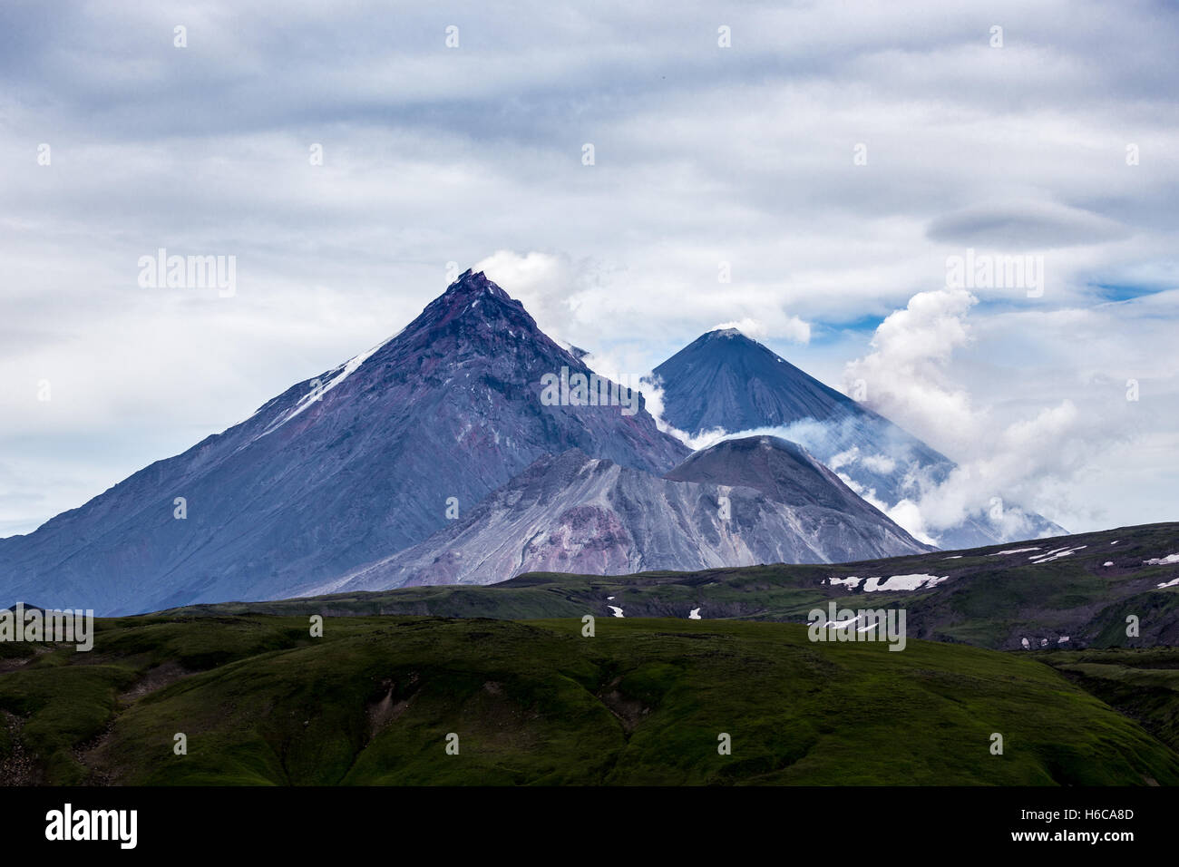 Three smoking volcanoes landscape, Kamchatka peninsula, Russia Stock ...