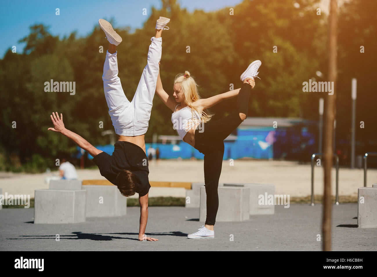 man and woman performing tricks Stock Photo - Alamy