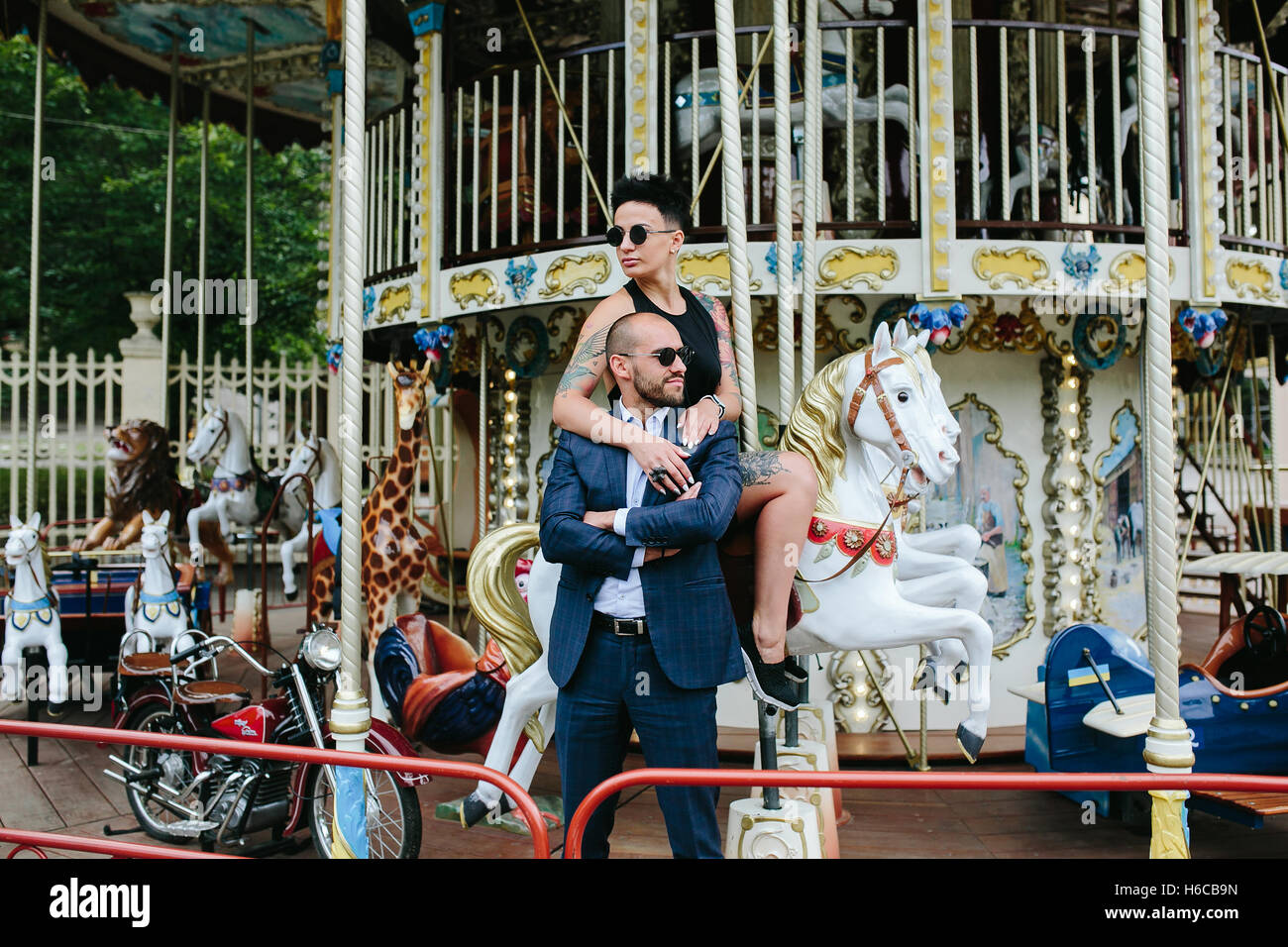 Adult man and woman on merry go round carousel hi-res stock photography ...