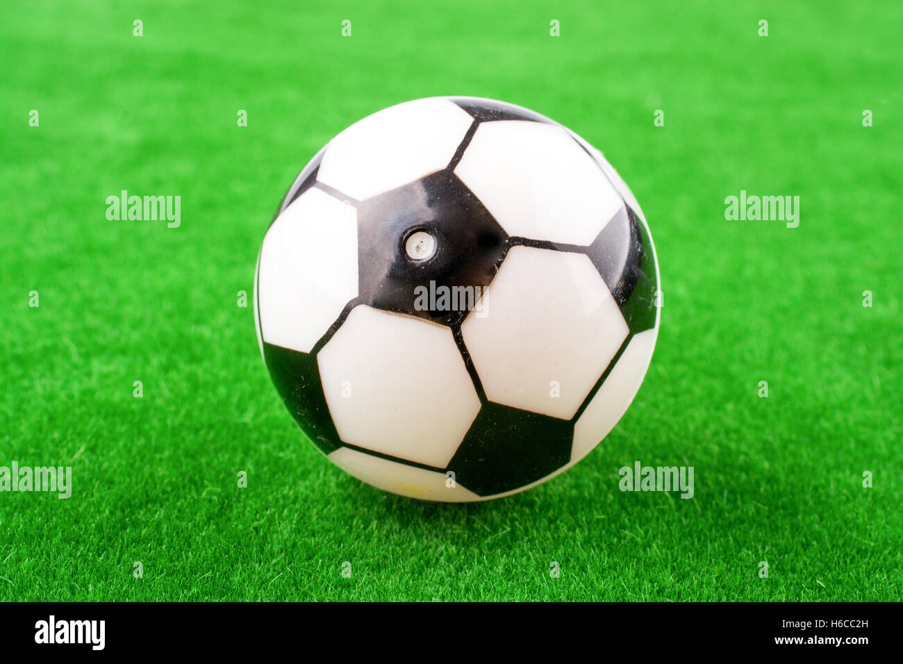 Fake soccer ball on a fake green grass field Stock Photo - Alamy