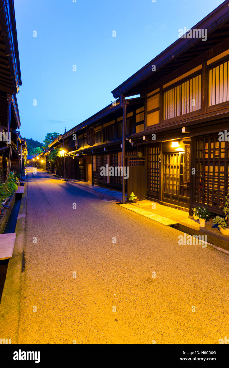 Traditional Japanese dark wooden homes, restaurants lighted at night ...