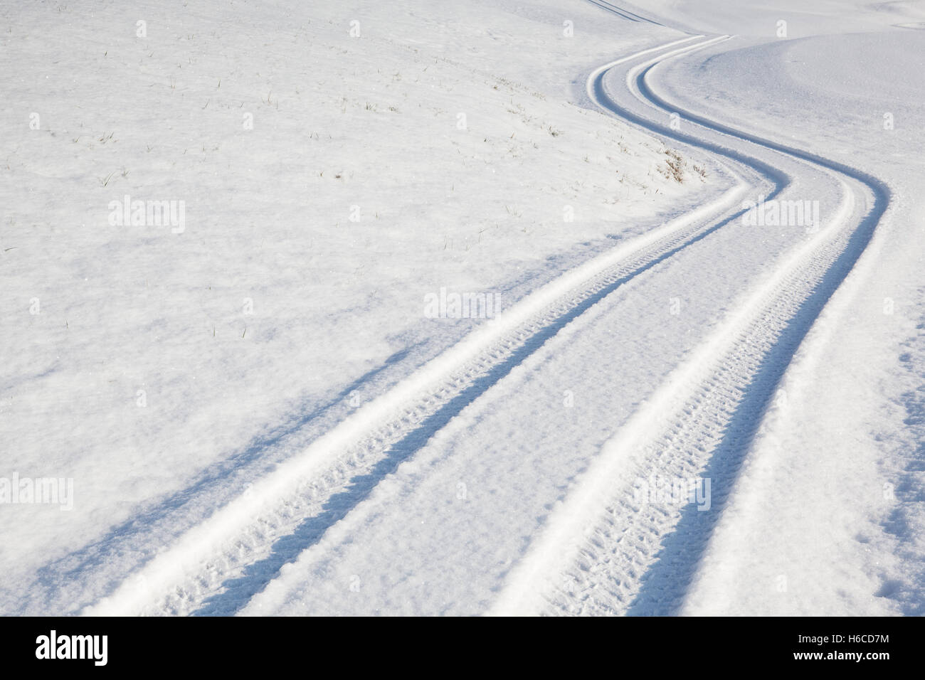 Car tire track on a empty winter road Stock Photo - Alamy