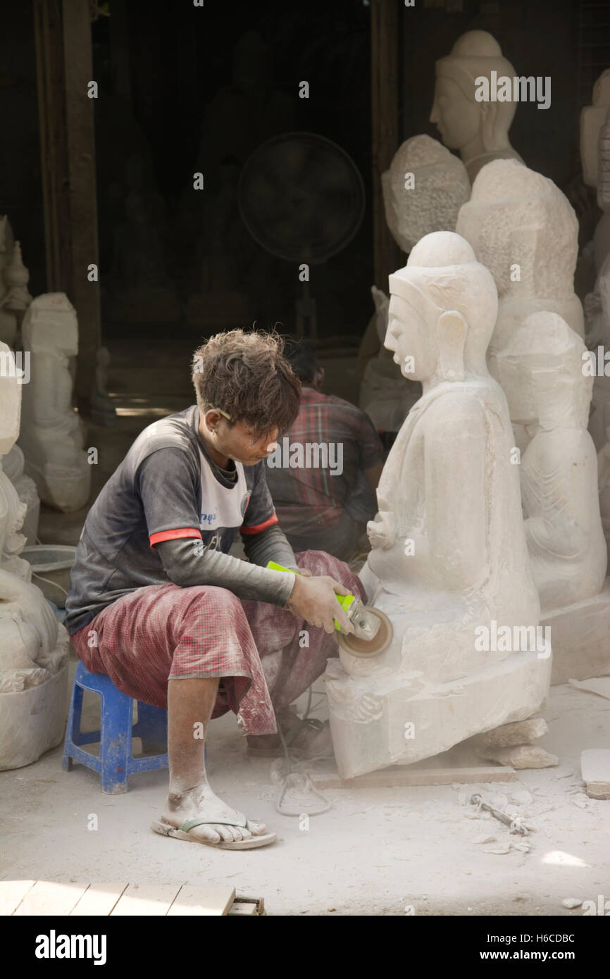 ASIA, MYANMAR (BURMA), Mandalay, man using an electric sanding machine ...