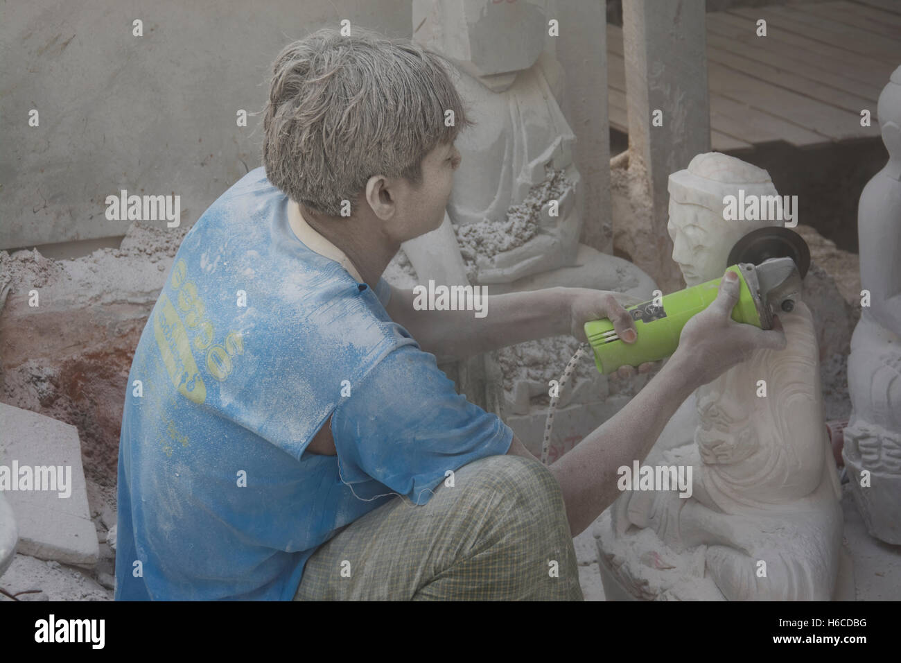 ASIA, MYANMAR (BURMA), Mandalay, man using an electric sanding machine ...