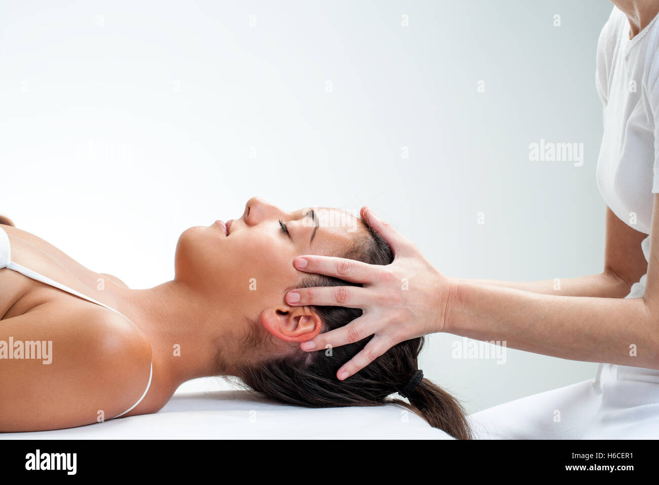 Close up of chiropractor doing healing osteopathic treatment on woman ...