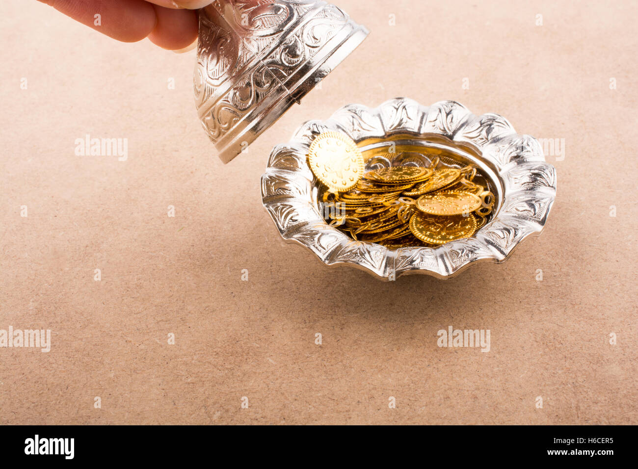 Fake gold coins in an old decorative metal plate Stock Photo - Alamy