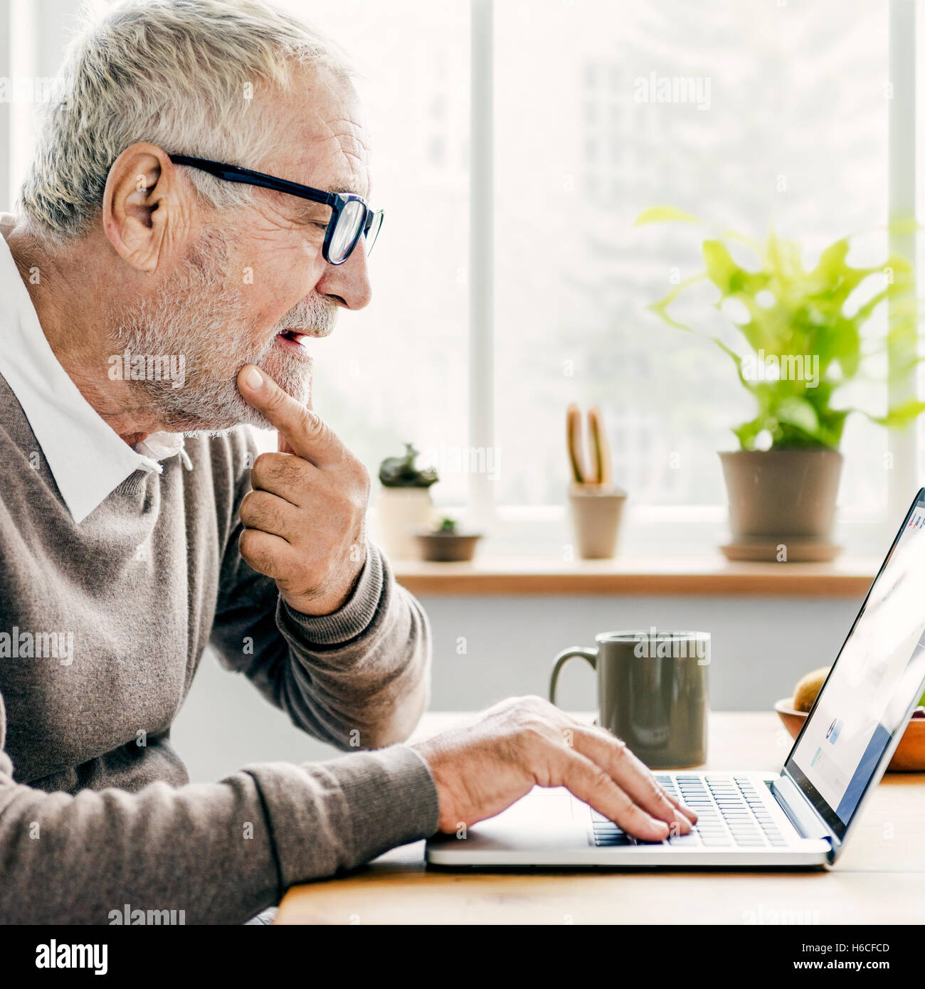 Senior Adult Using Laptop Thinking Concept Stock Photo - Alamy