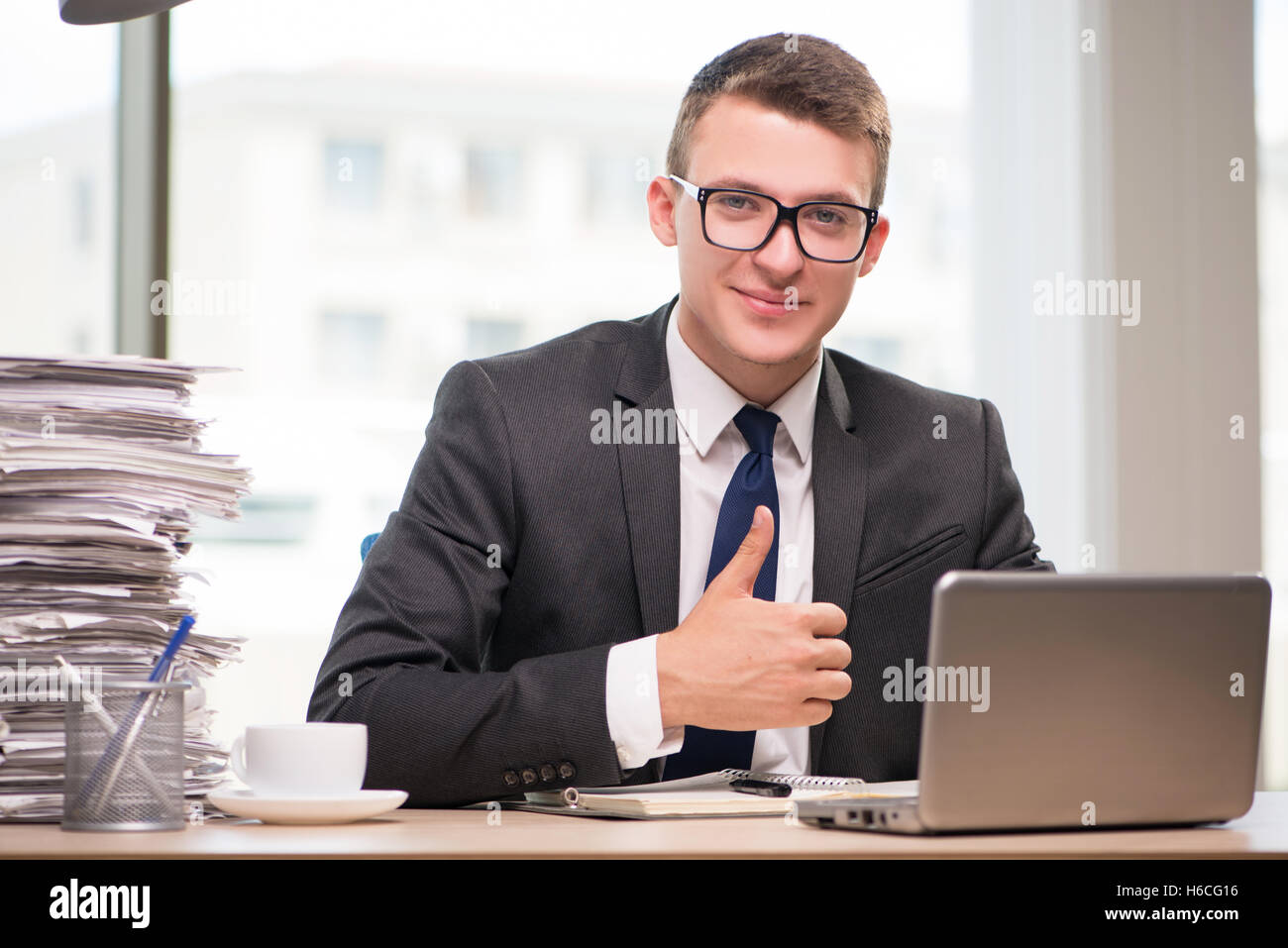 Businessman working with much paperwork Stock Photo - Alamy