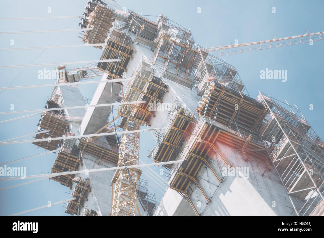 Multiple scaffolding, construction crane on a modern rope bridge under ...