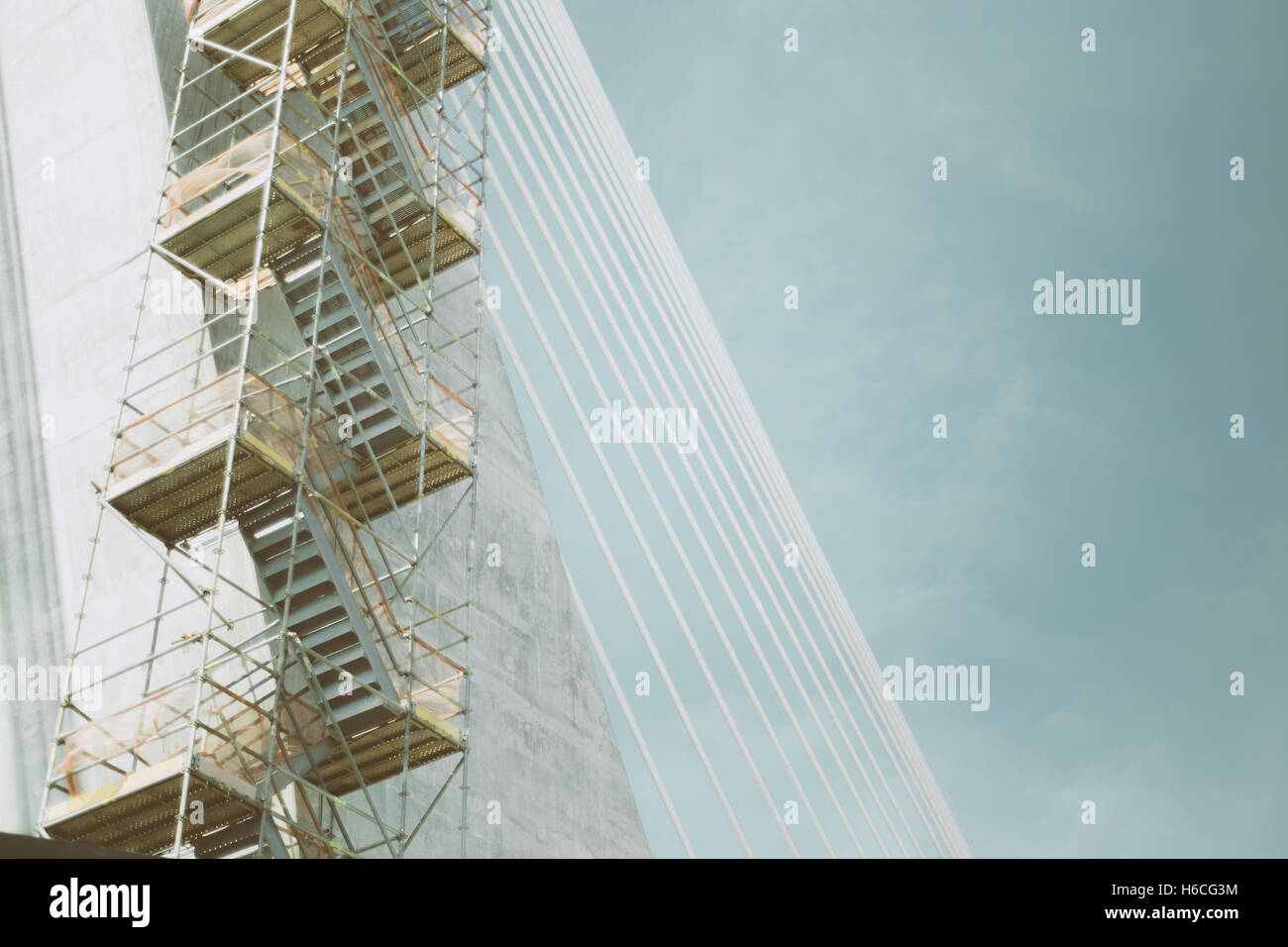 Rope bridge under construction with regular metal ropes and scaffolding ...