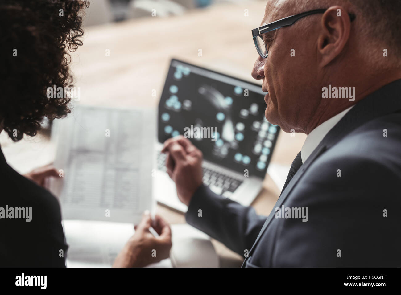 Reading through the company numbers together Stock Photo - Alamy