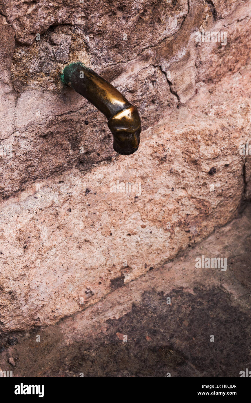 ancient bronze faucet and old wall Stock Photo - Alamy