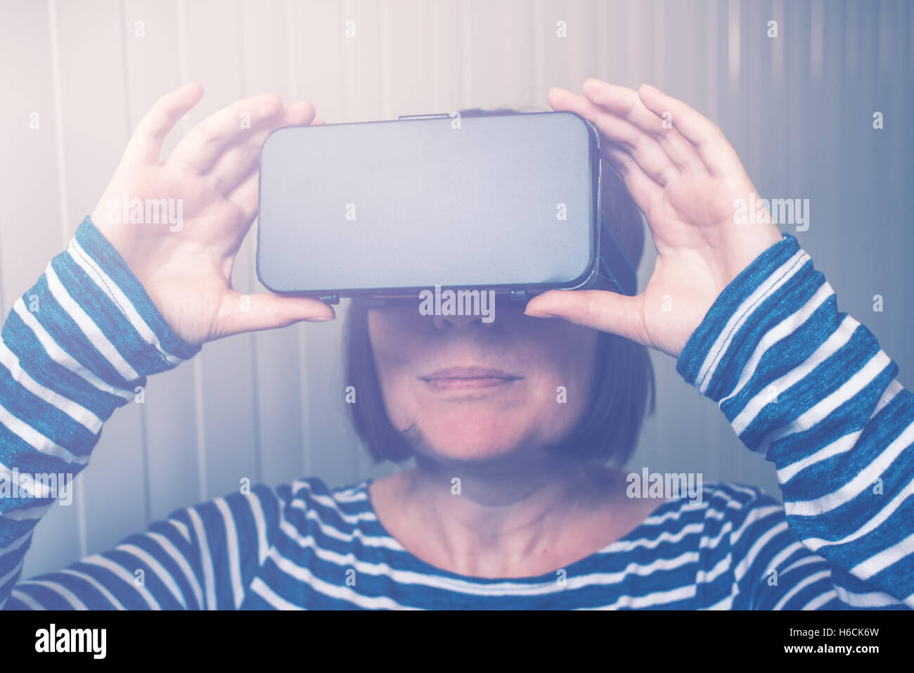 Woman watching 360 video with virtual reality headset. Female using VR ...
