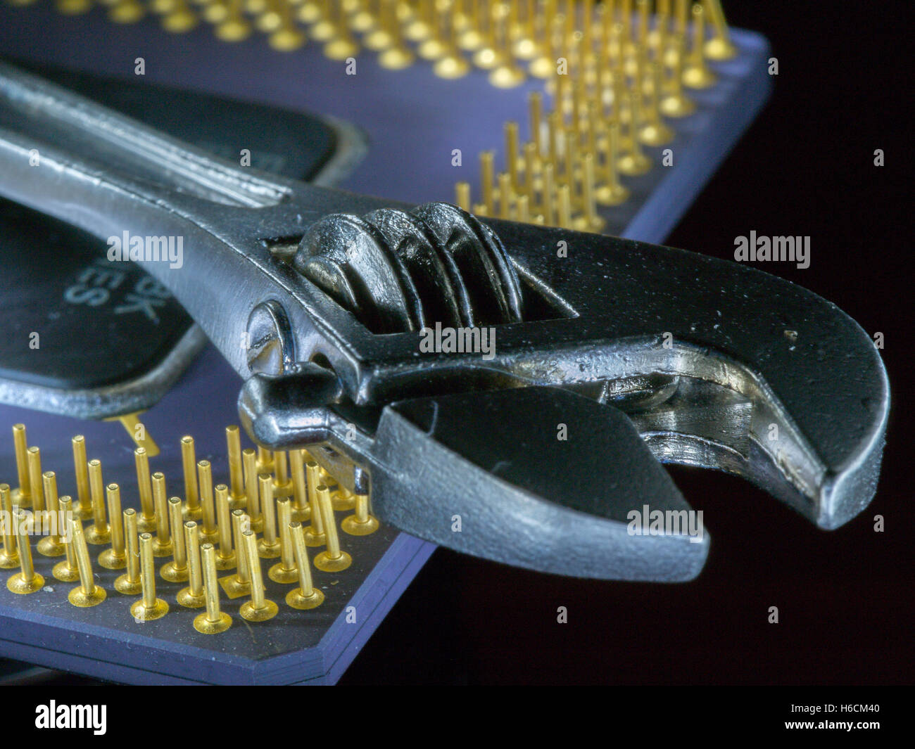 Adjustable wrench and the computer processor Stock Photo - Alamy