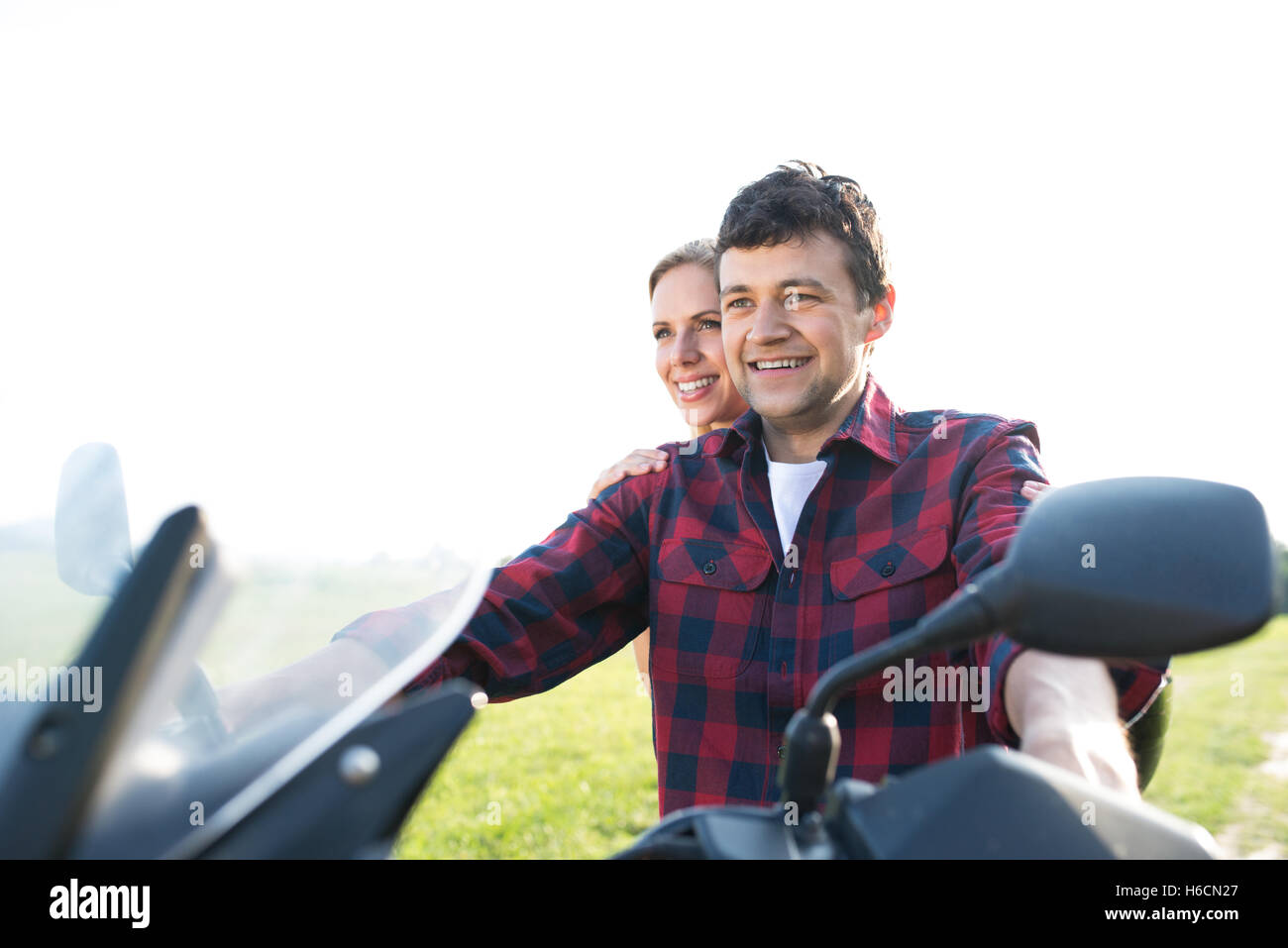 Beautiful young couple in love enjoying a quad bike ride in countryside ...