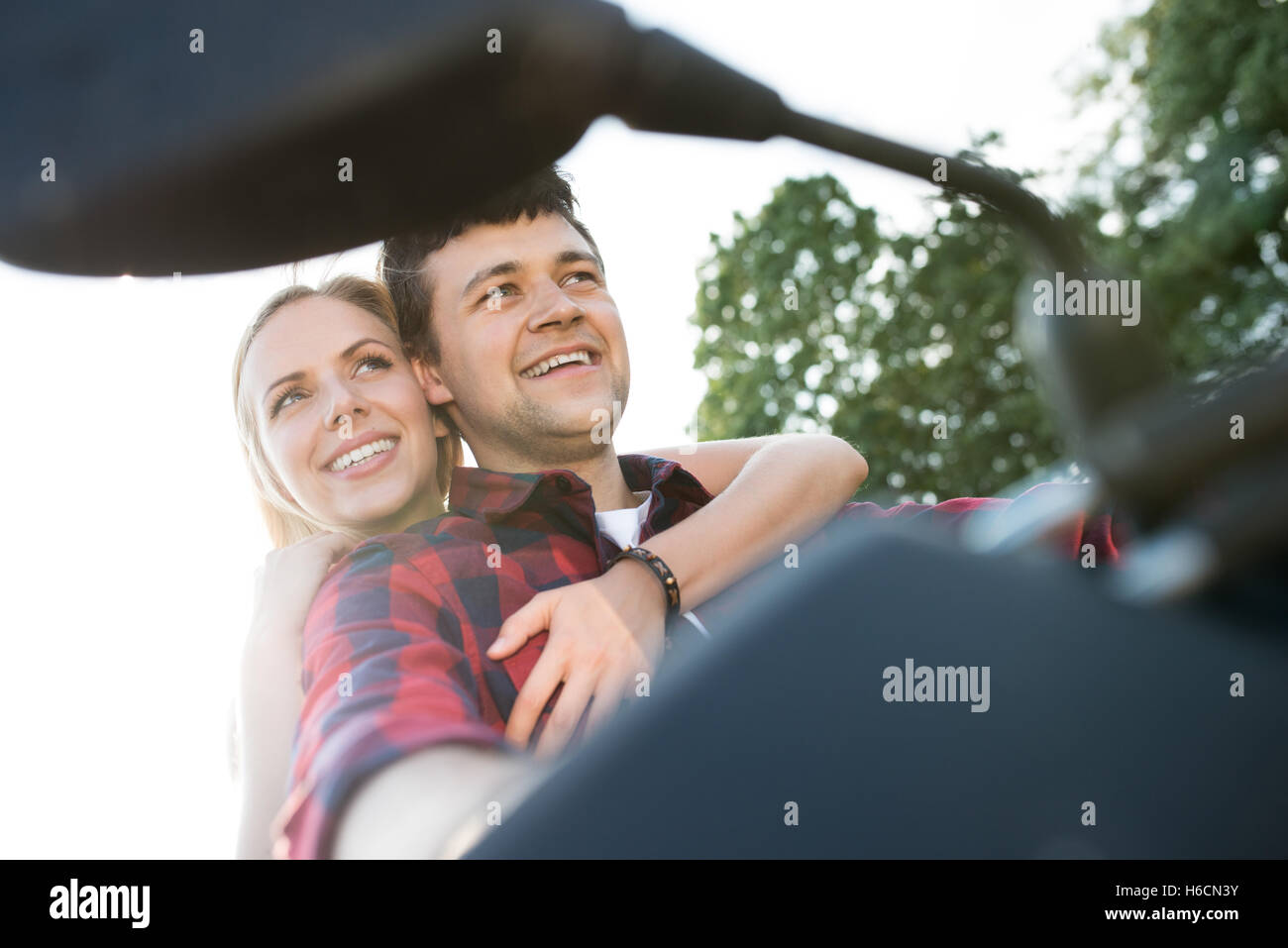 Beautiful young couple in love enjoying a quad bike ride in countryside ...