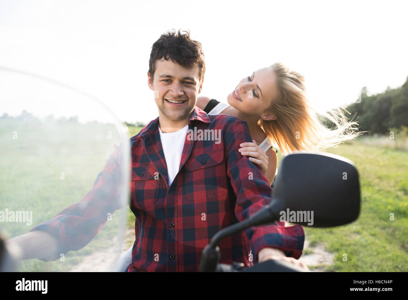 Beautiful young couple in love enjoying a quad bike ride in countryside ...