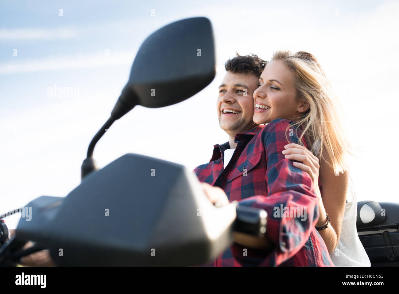 Beautiful young couple in love enjoying a quad bike ride in countryside ...