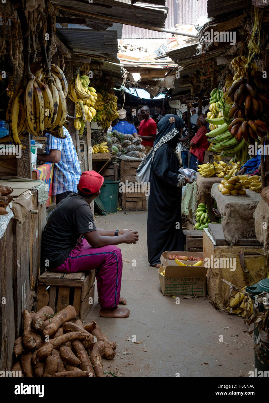 A muslim woman in Chador or a shayla decides what bananas to buy in the ...