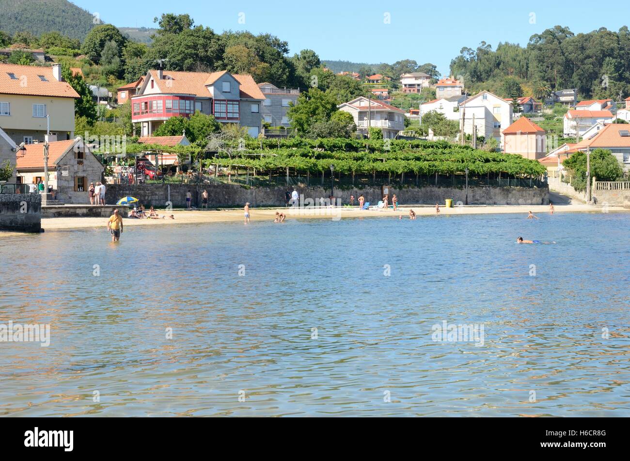 People at the beach of the village of Combarro, in the province of ...