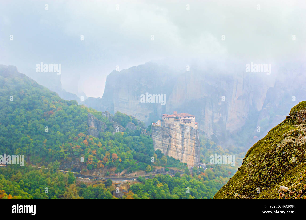 The Holy Monastery of Varlaam and Meteora mountains in the fog after ...