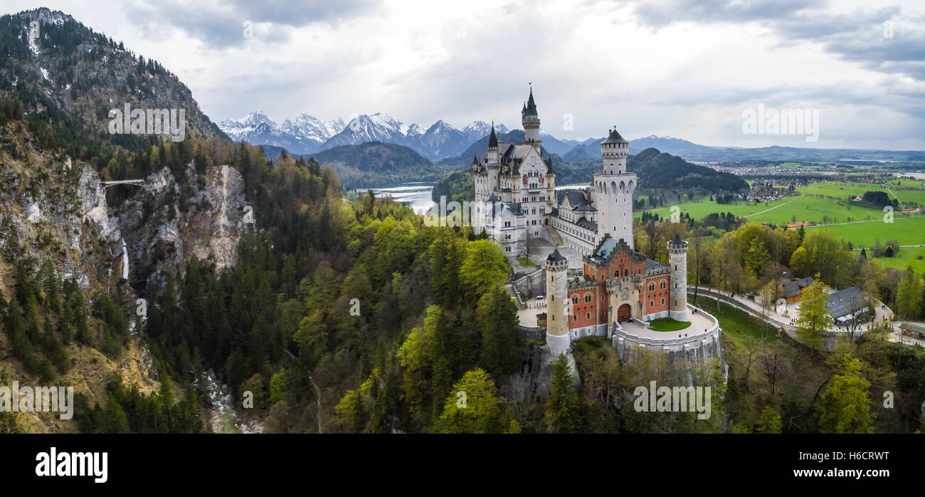 Aerial view of Neuschwanstein Castle with Lake Alpsee and Bavarian Alps ...