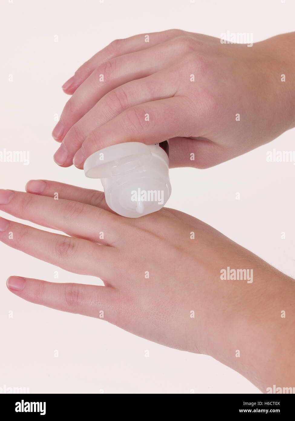 Applying hand cream Stock Photo - Alamy