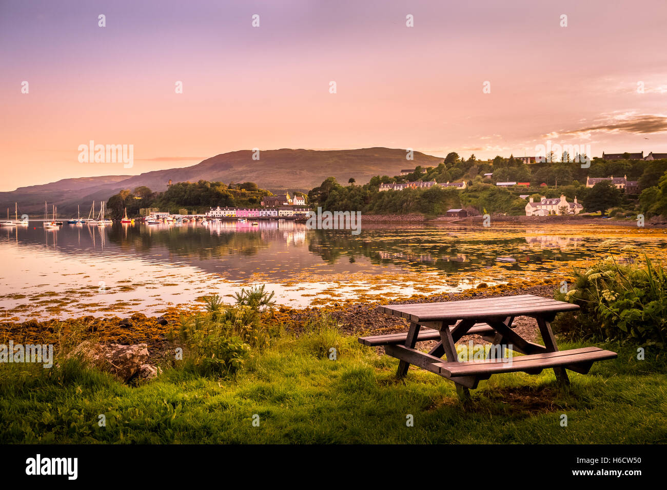 Picnic table at the shore of Portree bay on the Isle fo Skye, Scotland ...