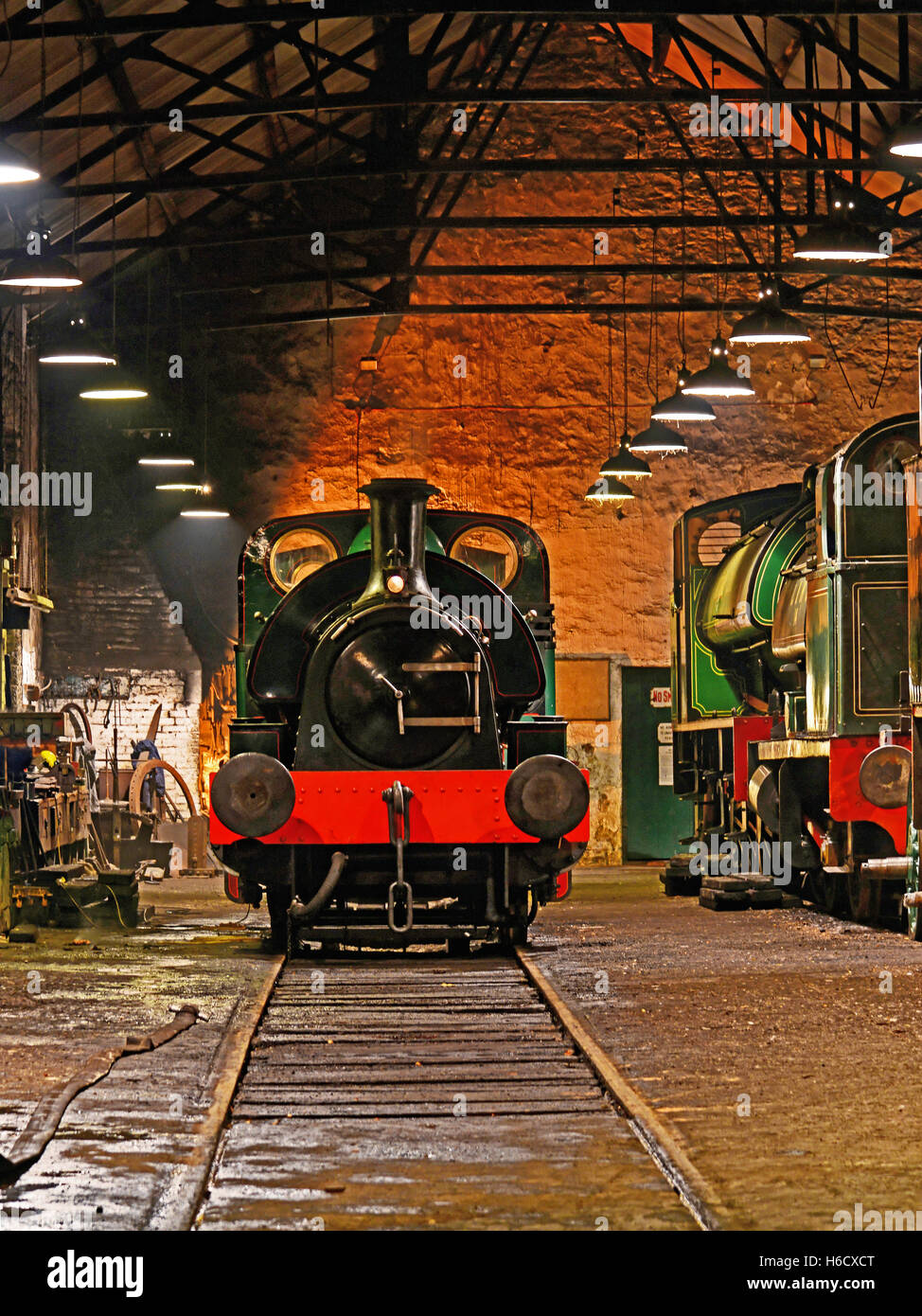 Steam railway engine in sheds awaiting repair Stock Photo - Alamy